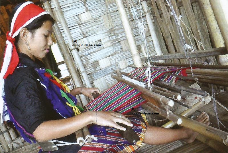 A Tangsa tribal girl weaving on a traditional loom at a local Tangsa ...